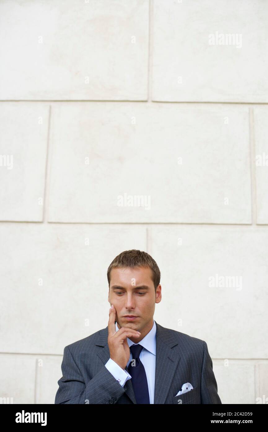 Reflective businessman looking down Stock Photo - Alamy