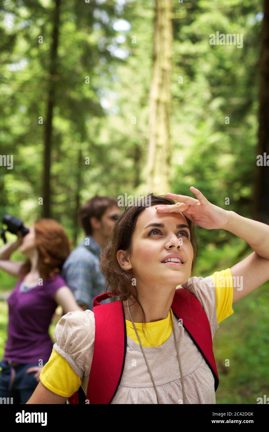 Young woman in a forest looking up Stock Photo - Alamy