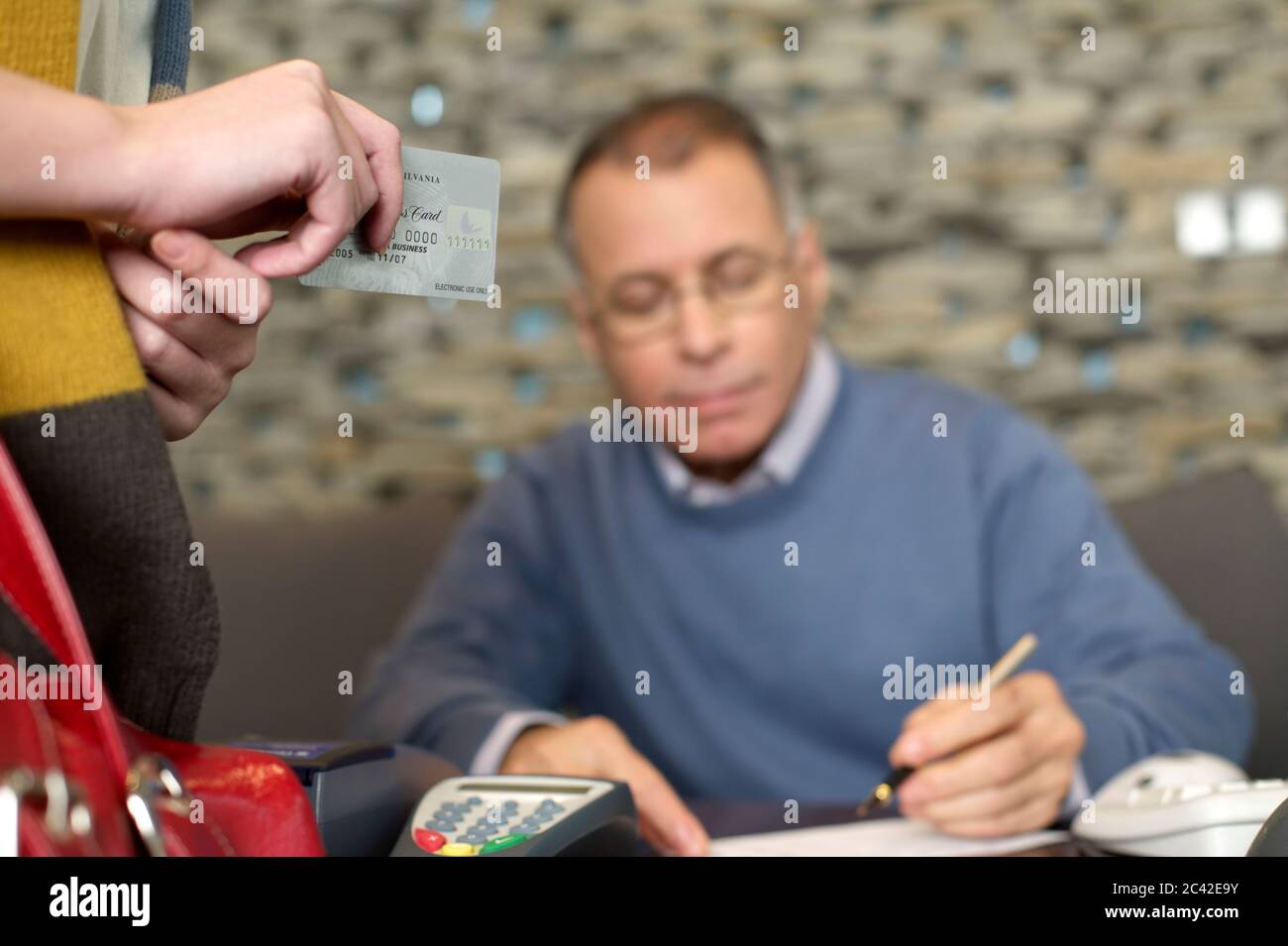Man writes out receipt Stock Photo - Alamy