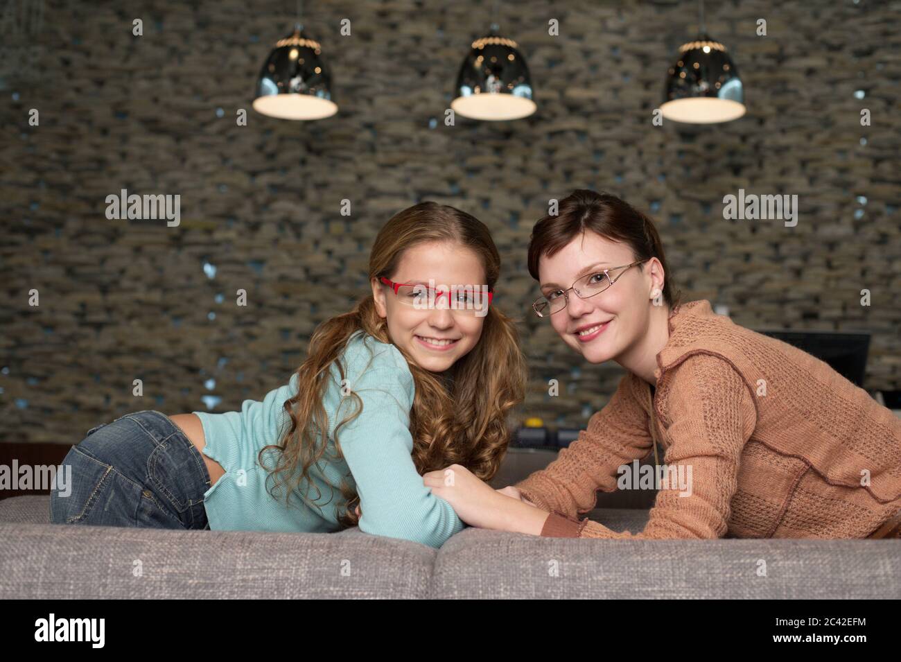 Mother and daughter with new glasses look at the camera Stock Photo - Alamy
