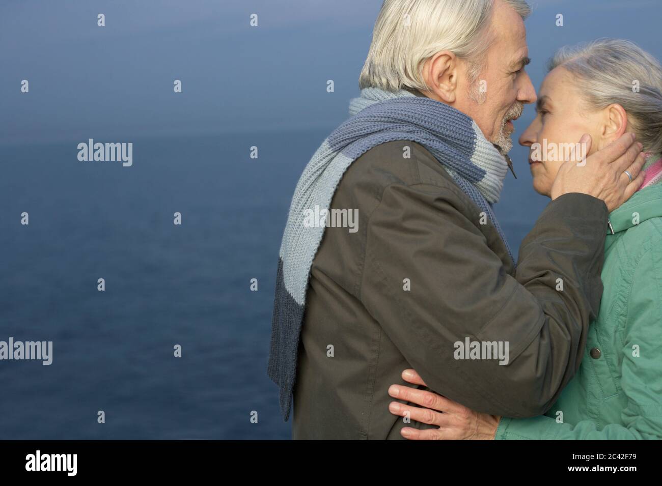 Old couple hugging - romance - winter Stock Photo - Alamy