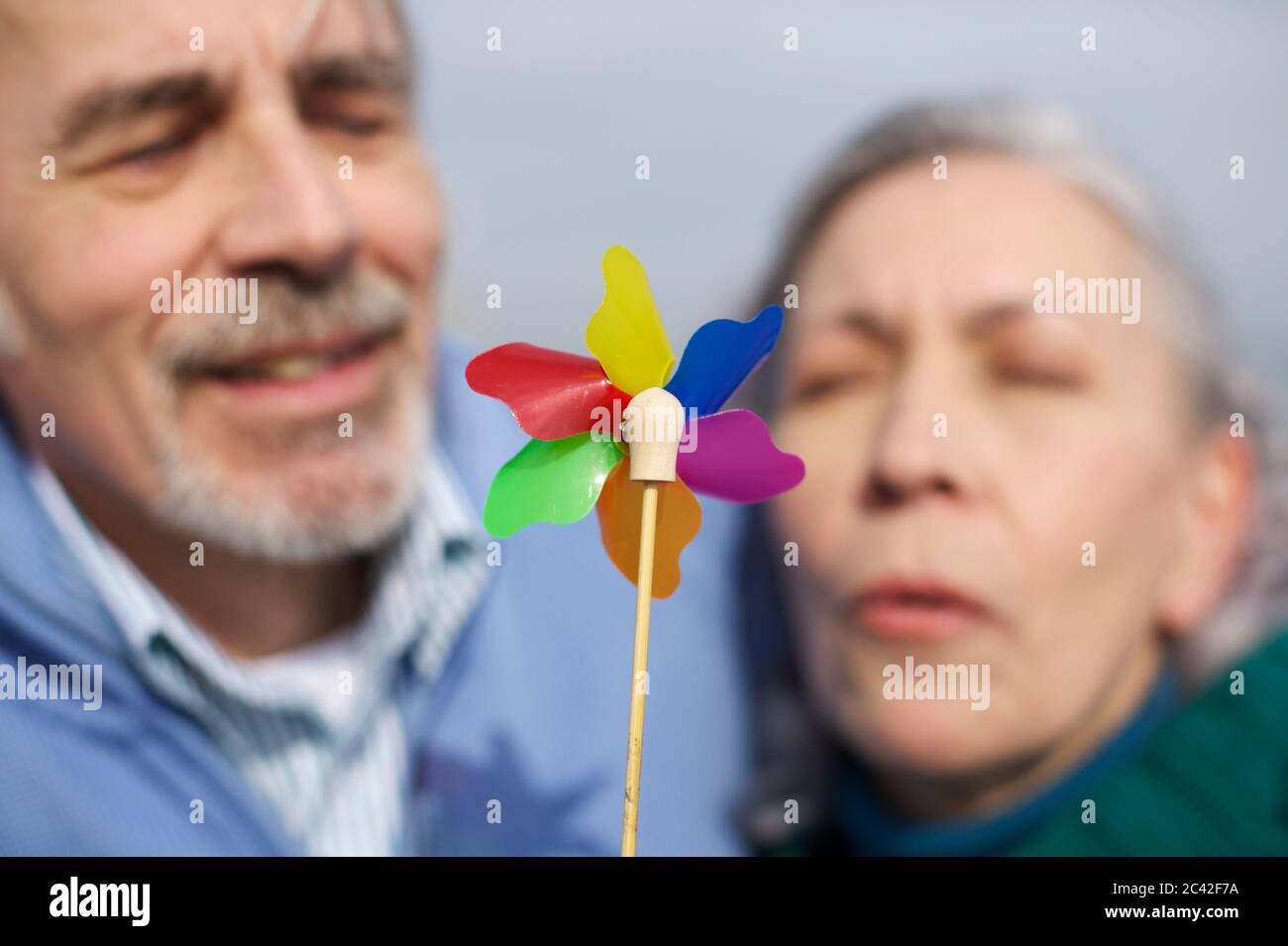 Old couple with a pinwheel - fun - togetherness Stock Photo - Alamy