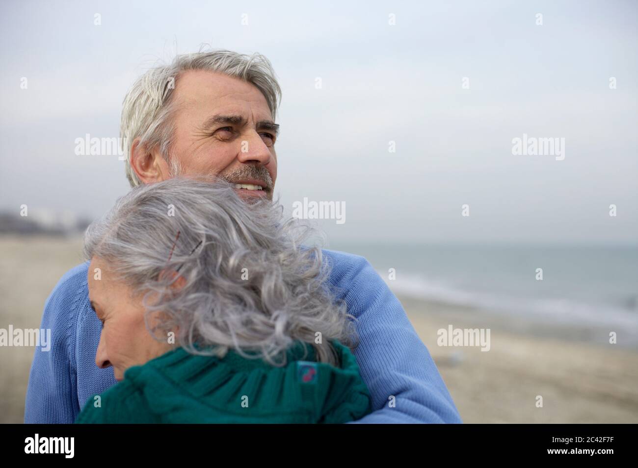 Old couple hugging - romance - winter Stock Photo - Alamy