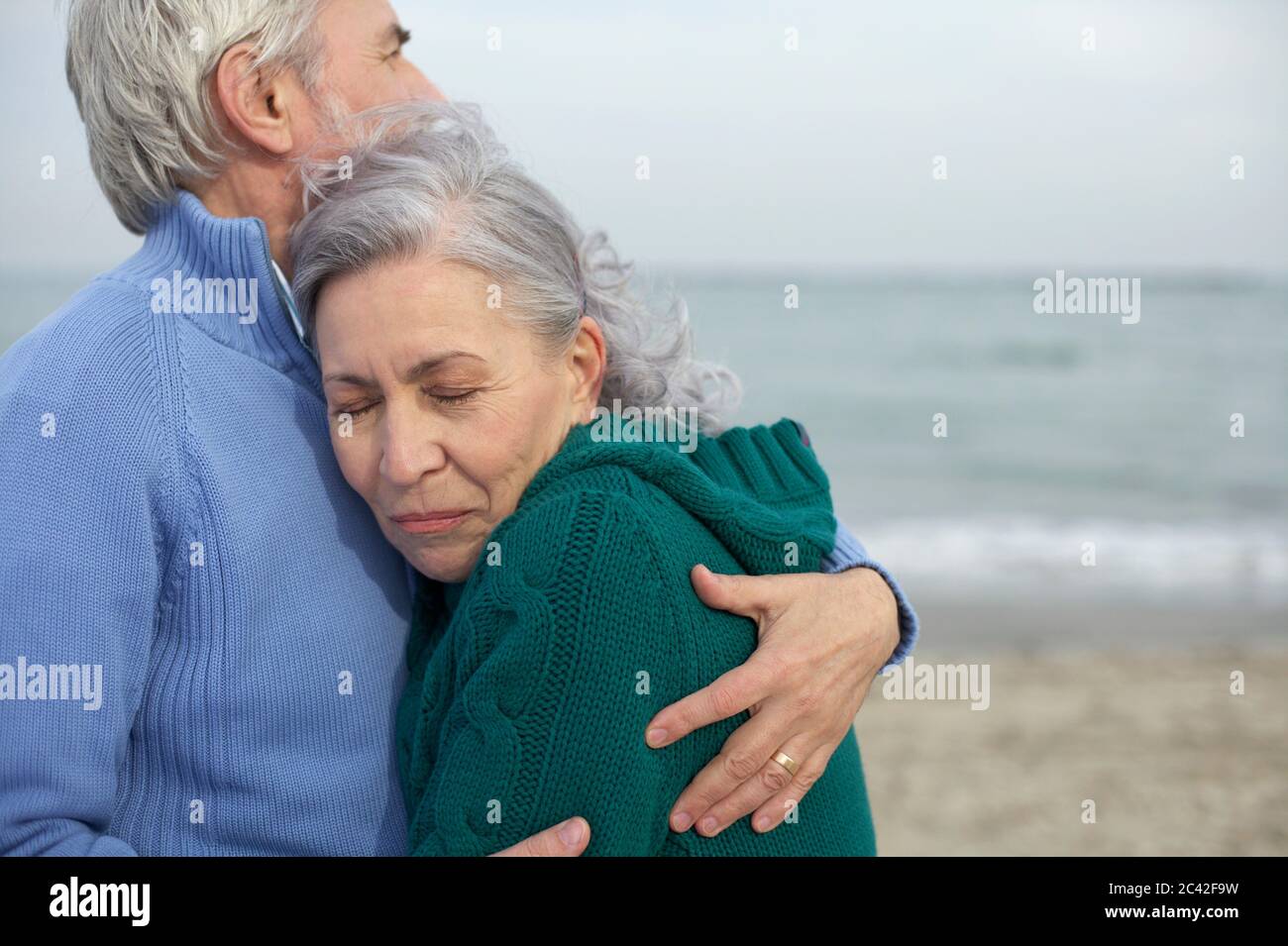 Old couple hugging - romance - winter Stock Photo - Alamy