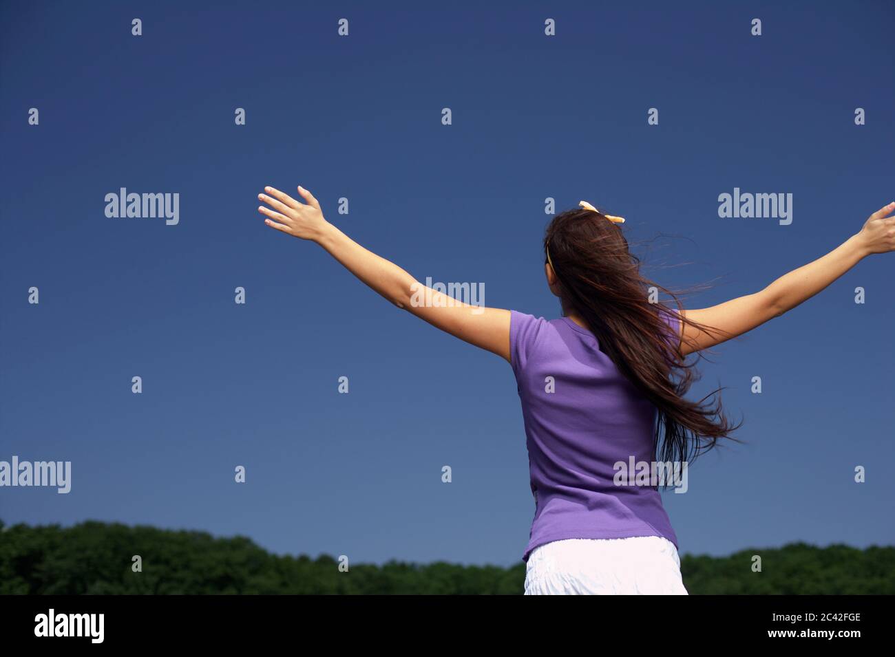 Young woman raises her arms Stock Photo - Alamy