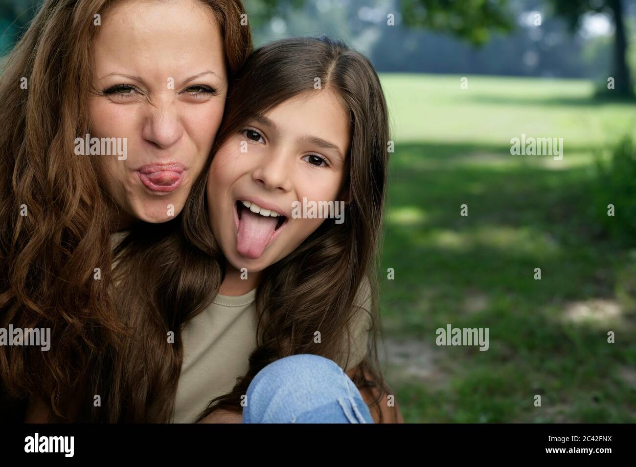 Mother and daughter stick out their tongues Stock Photo - Alamy