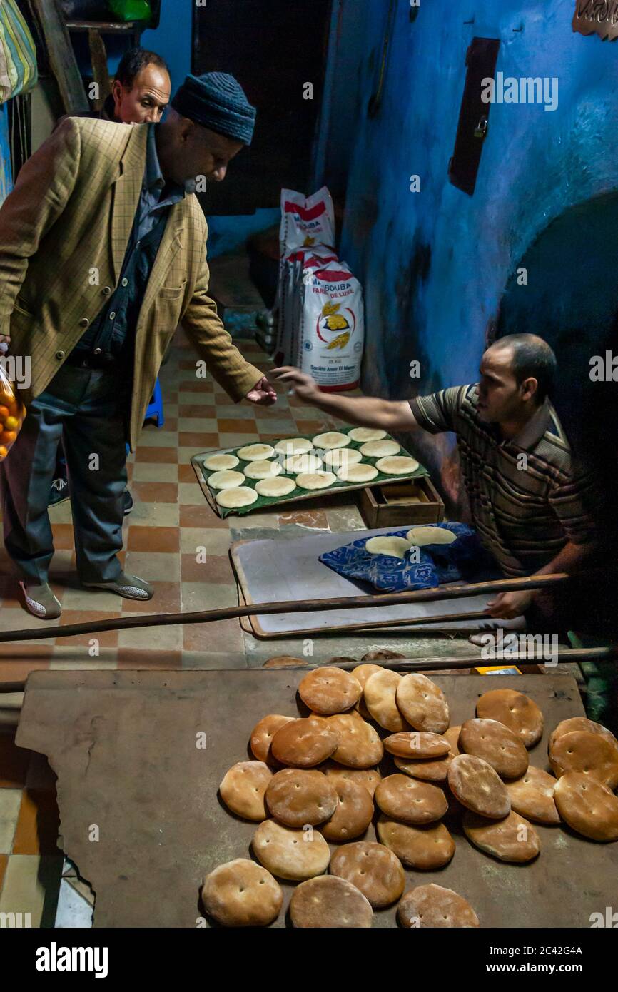 The baker in the medina of Fes bakes the customers' own loaves of bread ...