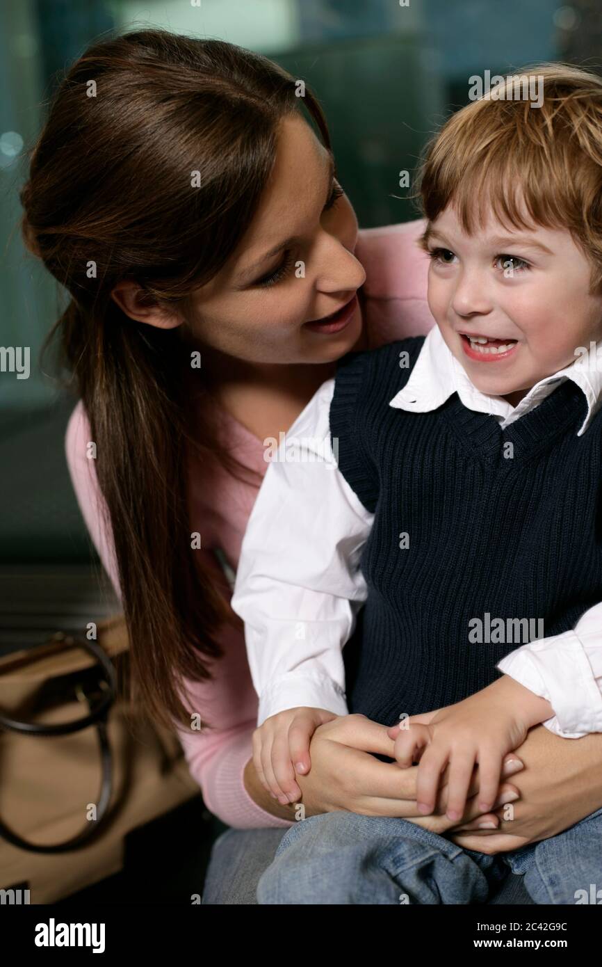 Mother holds son in her arms Stock Photo - Alamy