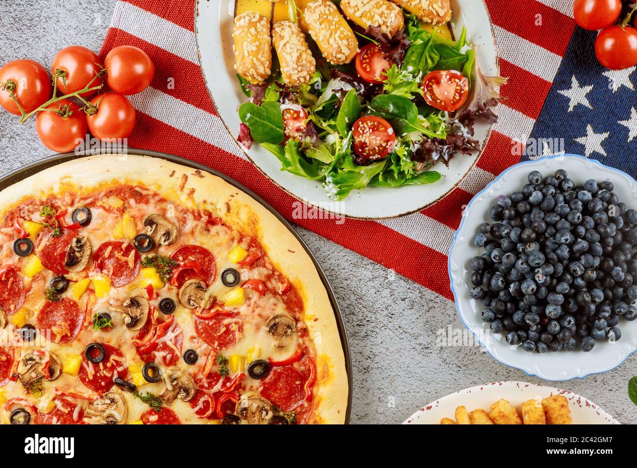 Independence Day party table with delicious food and flag for american ...