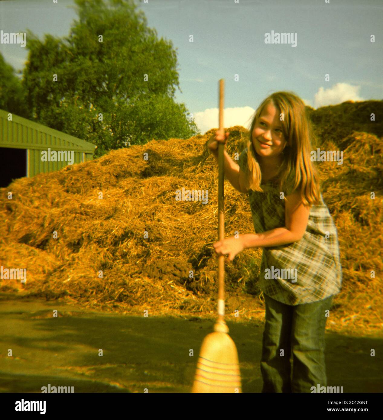 Girl sweeps on a farm Stock Photo - Alamy