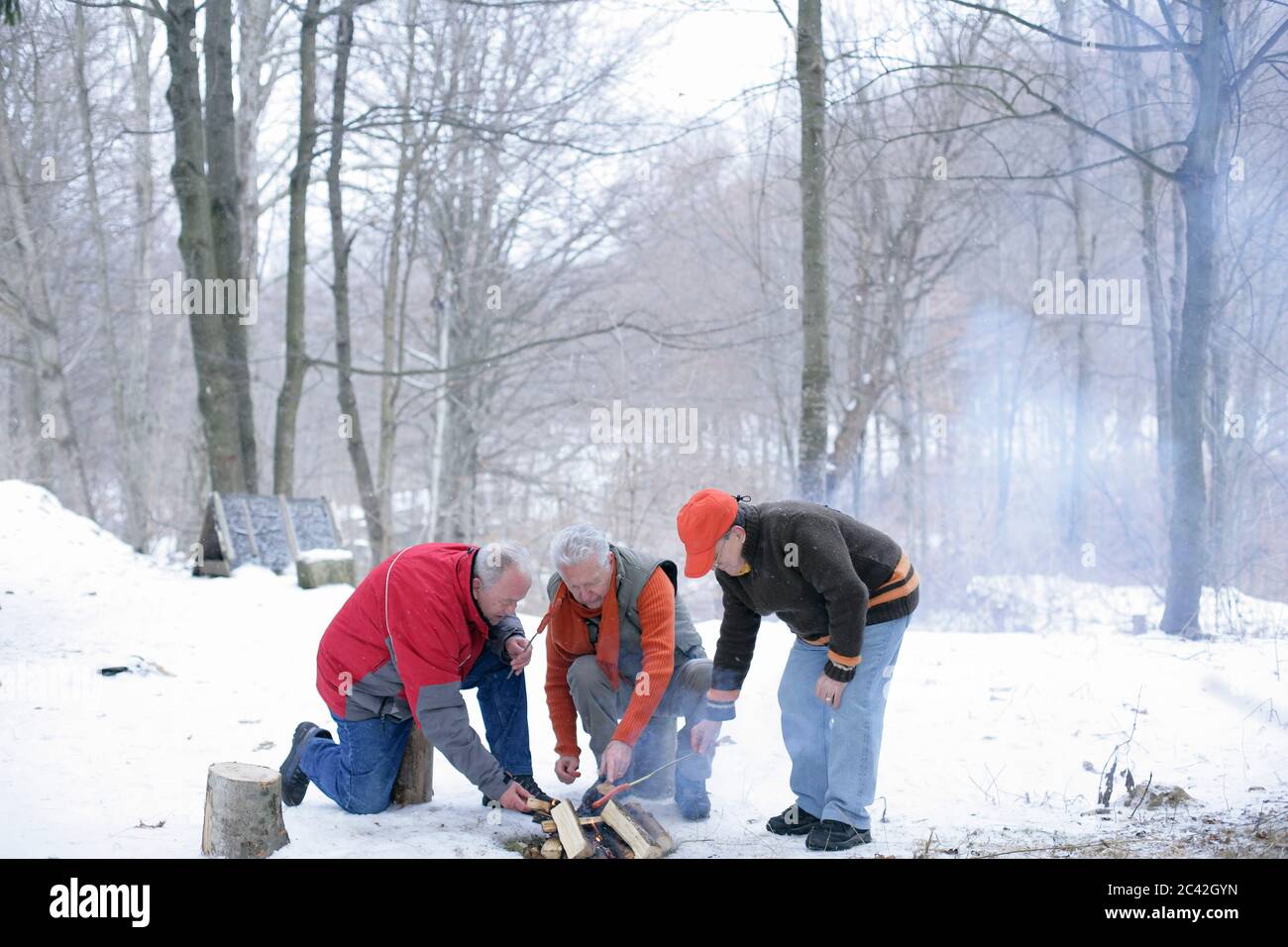 Three old men make a campfire Stock Photo - Alamy