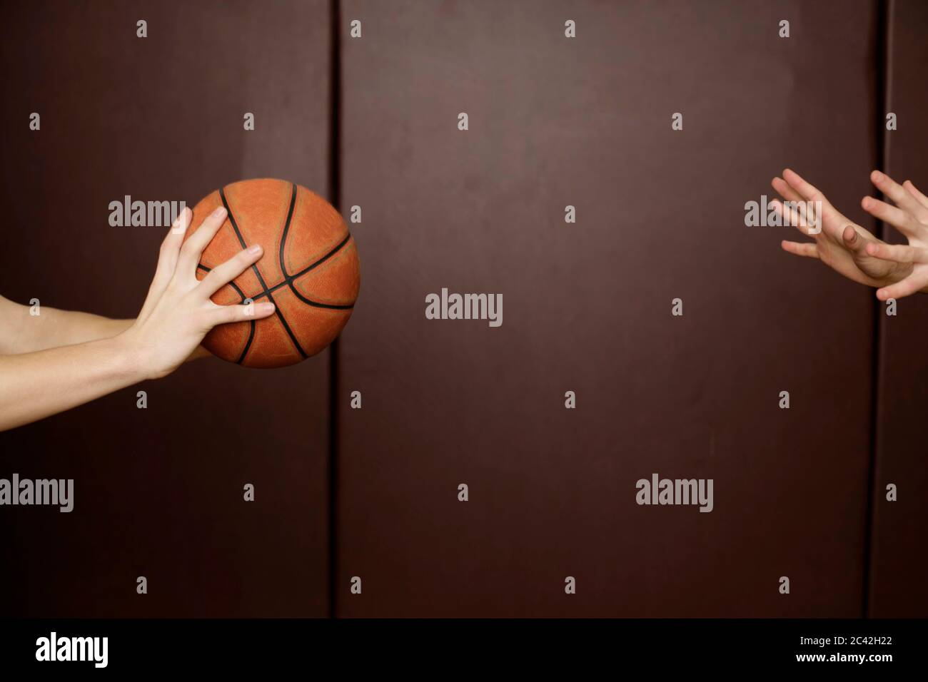 Two basketball players throw themselves a ball Stock Photo - Alamy