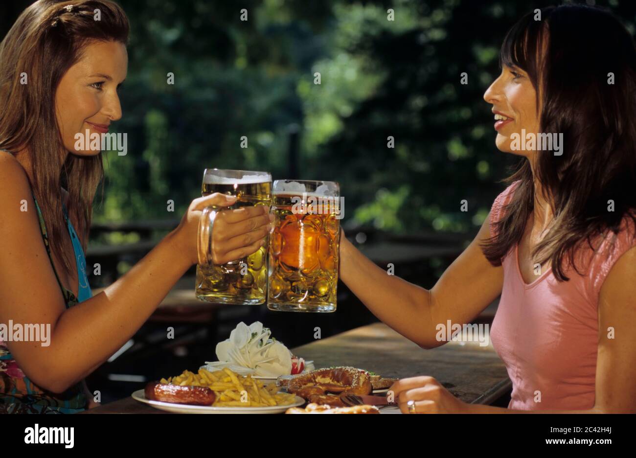Two friends clink glasses hi-res stock photography and images - Alamy