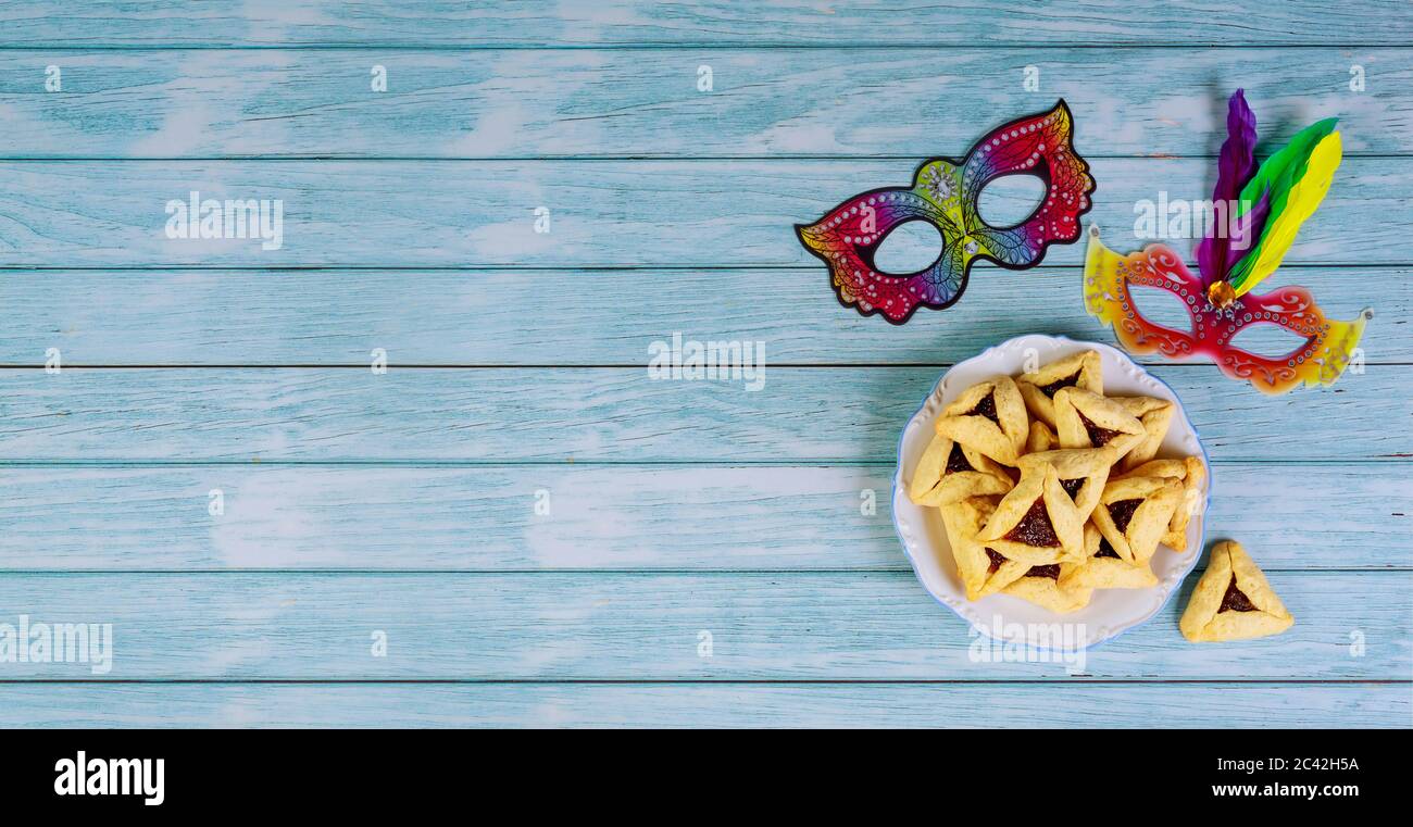 Purim background with masks and hamantaschen triangle cookies Stock ...