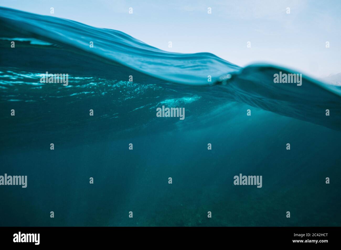 Split image of ripples in the ocean surface Stock Photo - Alamy
