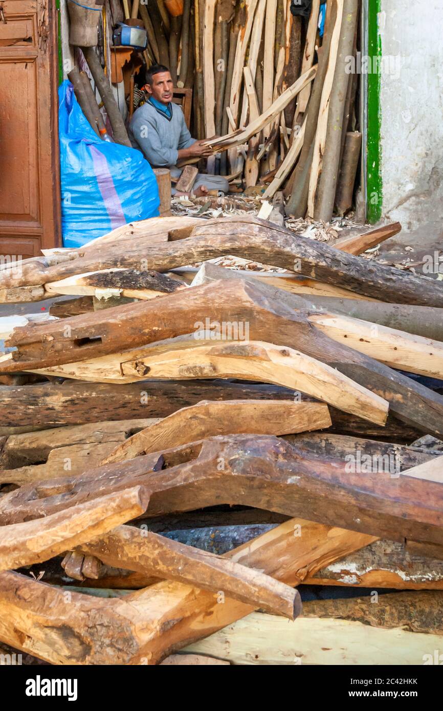 Craftsman manufacturing a wooden plow with traditional tools in Morocco ...