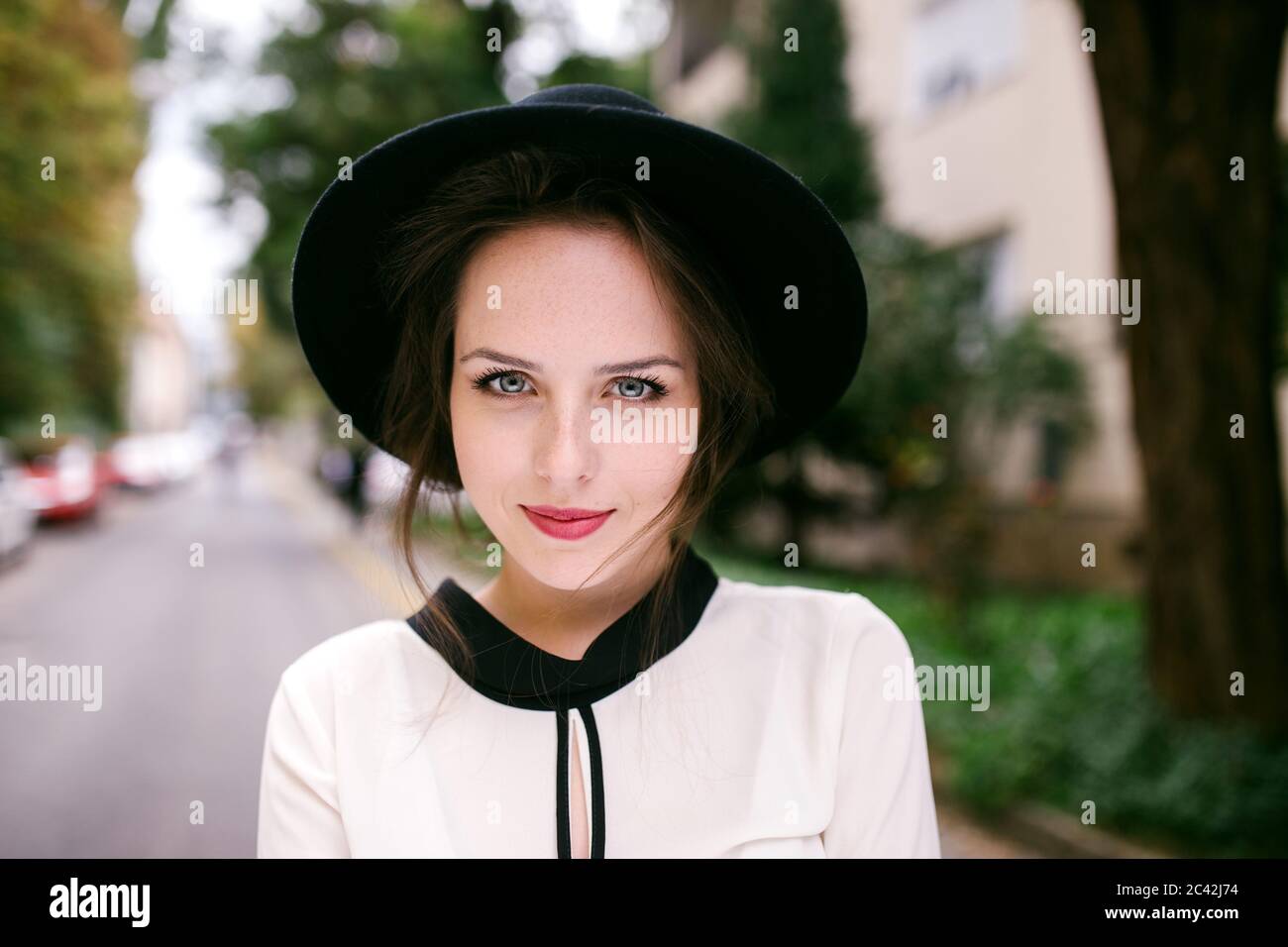 Portrait of young beatiful woman wearing black hat Stock Photo - Alamy Portrait of young beatiful woman wearing black hat Stock Photo - Alamy