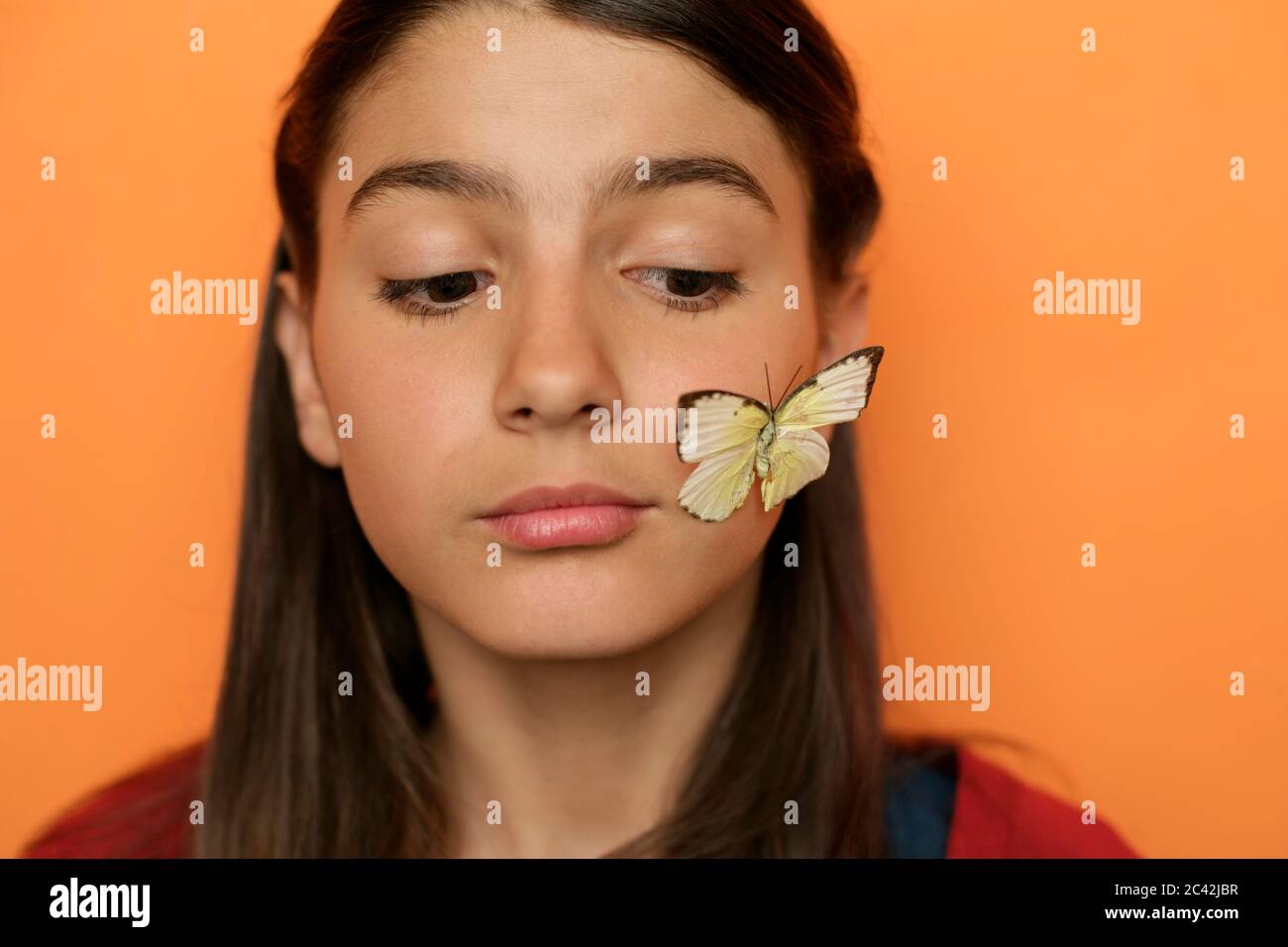 Girl with a butterfly on her cheek Stock Photo - Alamy