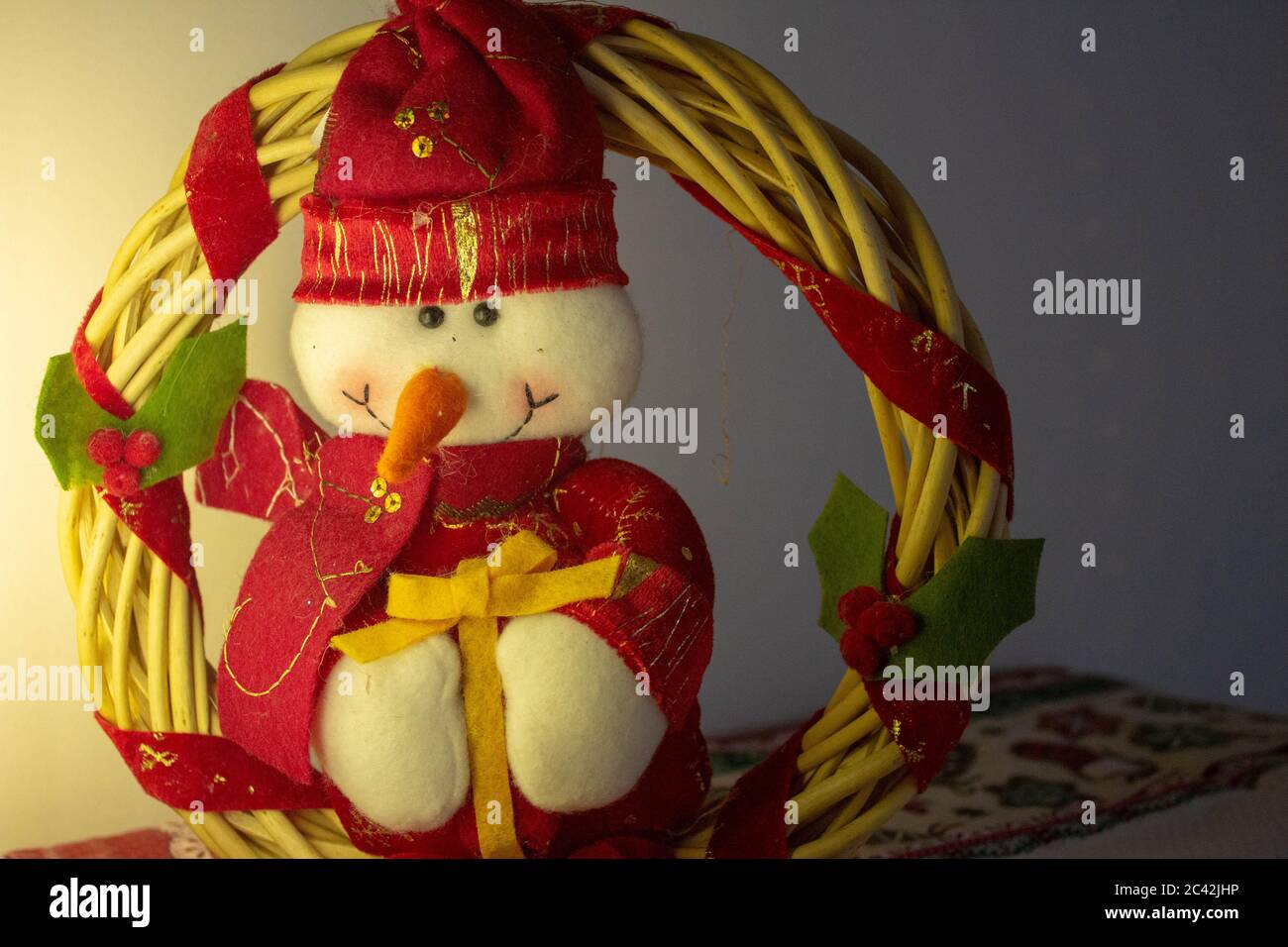 A christmas garland made of bamboo with a ahppy snowman dressed for ...