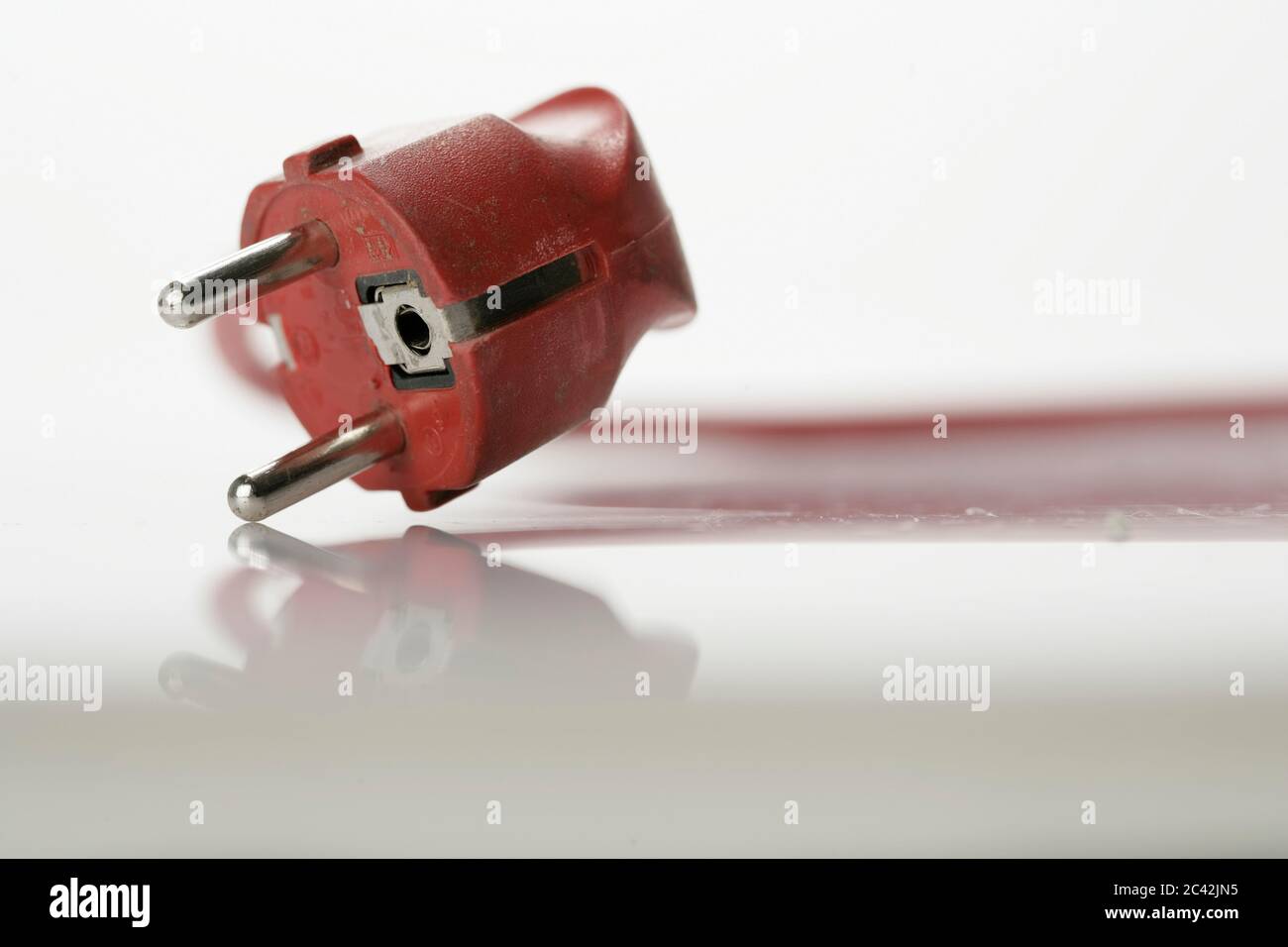 Plug on a red cable - electricity Stock Photo - Alamy