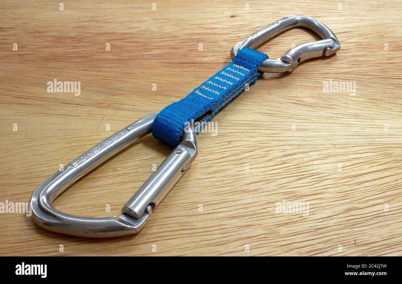 Rock climbing quickdraw with two aluminium carabiners and a blue sling ...