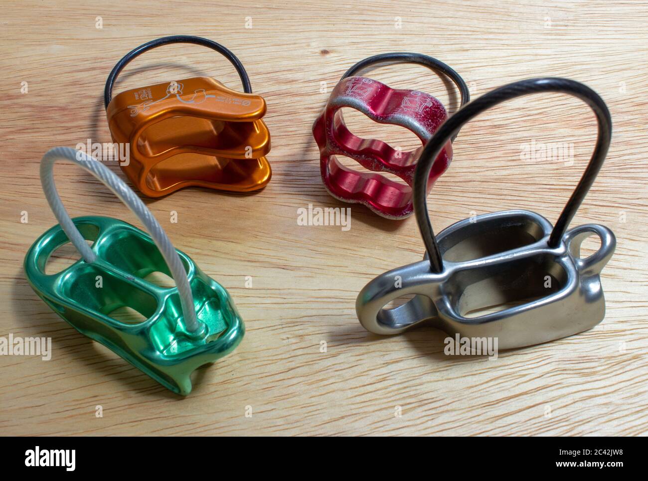 Four belay devices, two of them with guide mode function Stock Photo ...