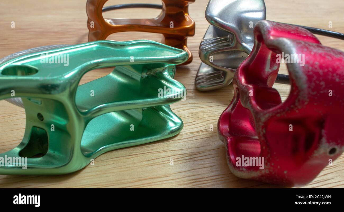 Four belay devices, two of them with guide mode function Stock Photo ...