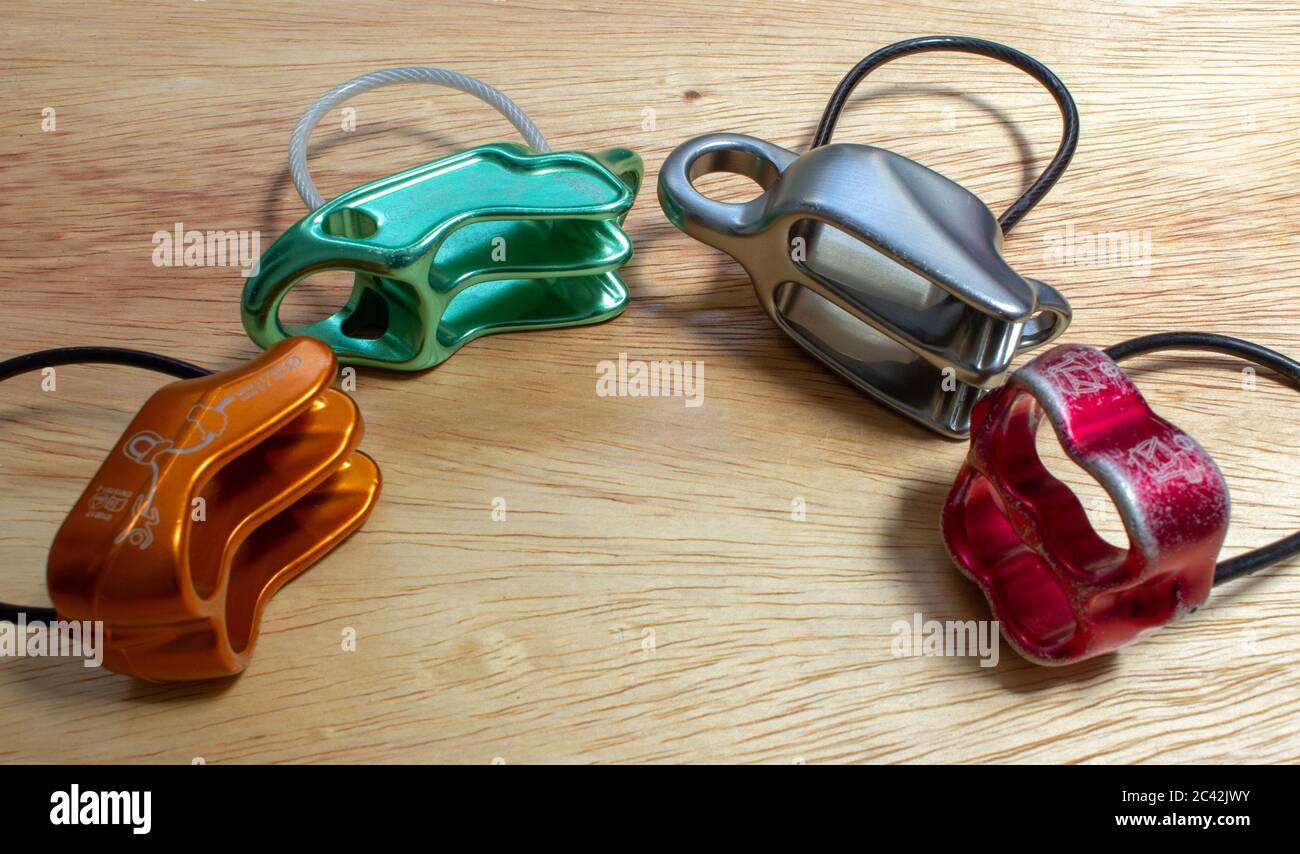 Four belay devices, two of them with guide mode function Stock Photo ...