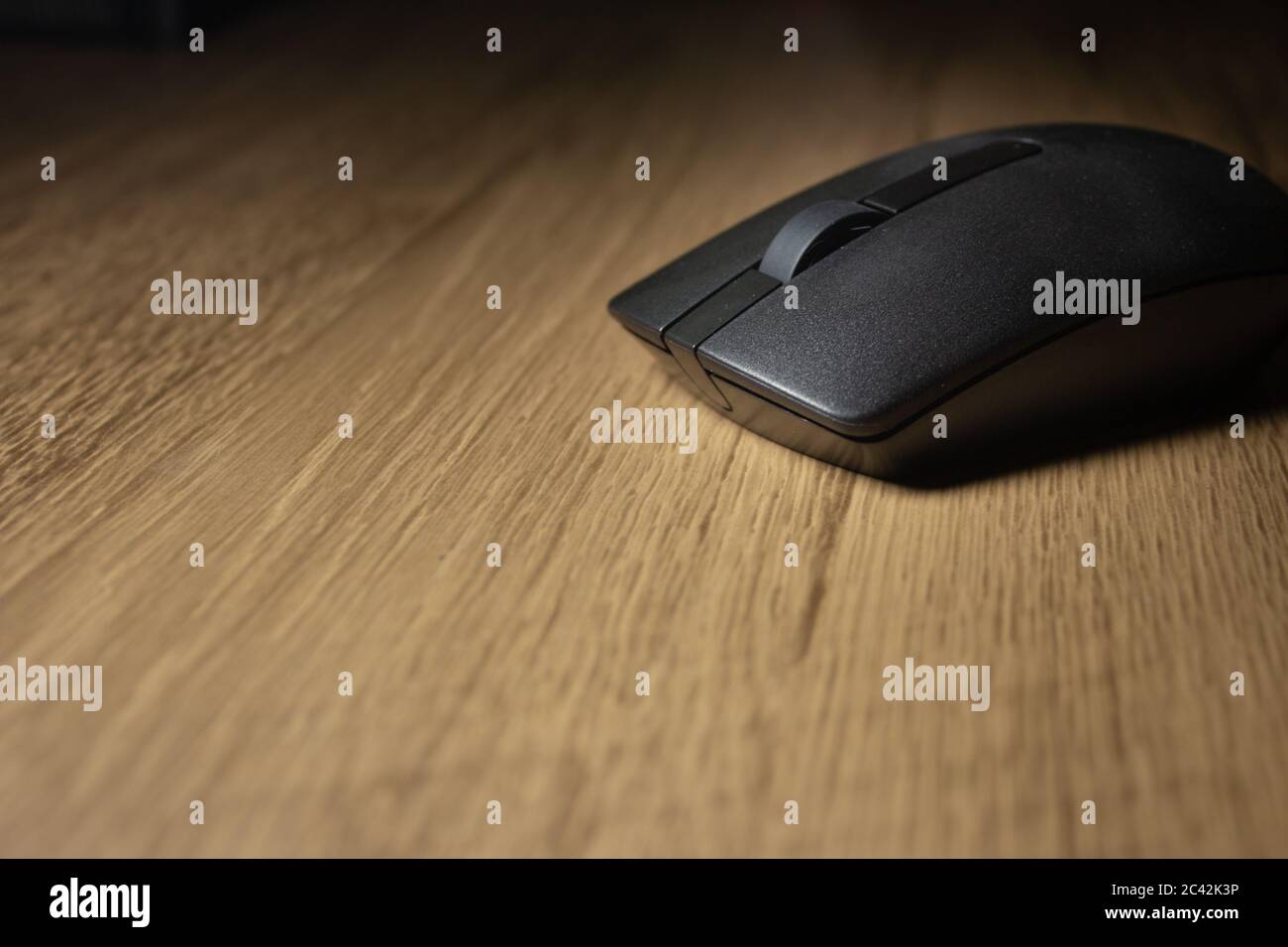 Wireless mouse on a wooden office desk Stock Photo - Alamy