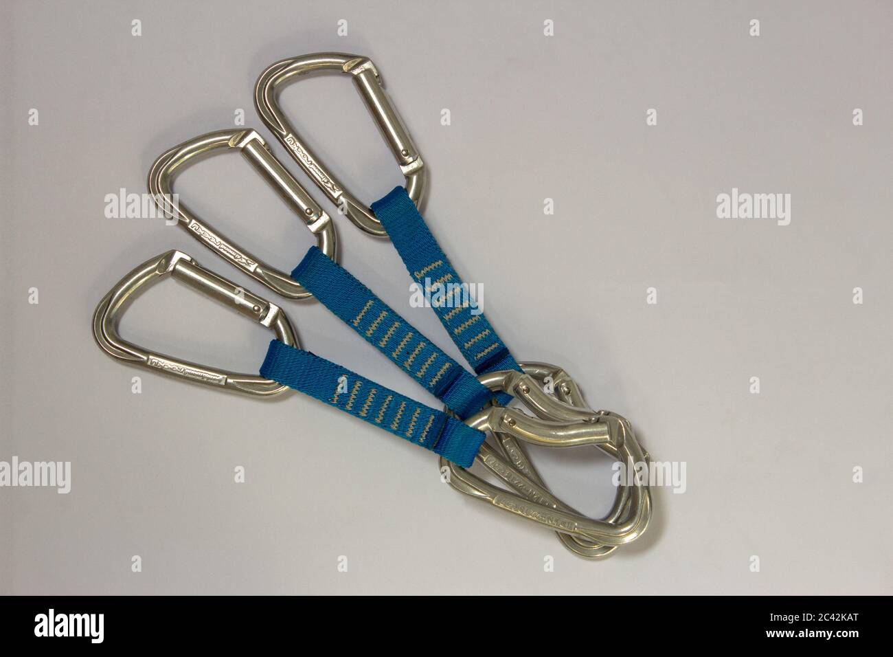 Tree rock climbing quickdraws, with aluminum carabiners and blue slings ...
