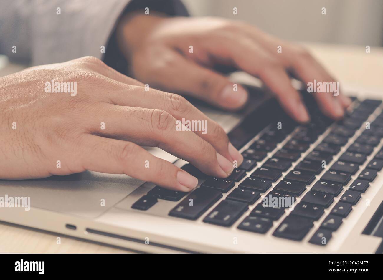 Men working at home on a laptop computer keyboard Stock Photo - Alamy
