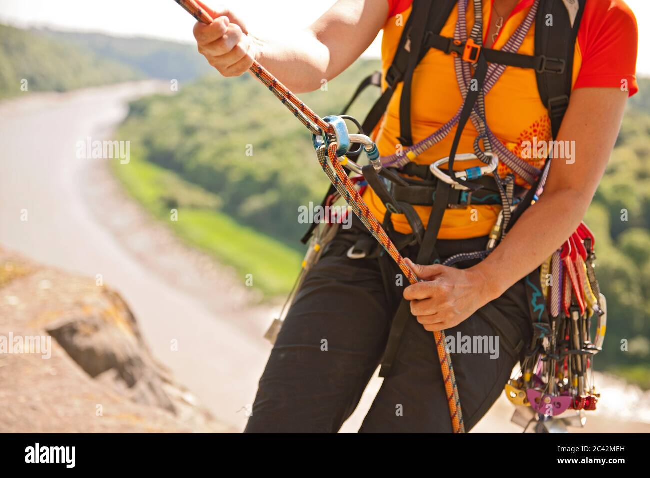 close up of woman rappelling of cliff in south Wales Stock Photo - Alamy