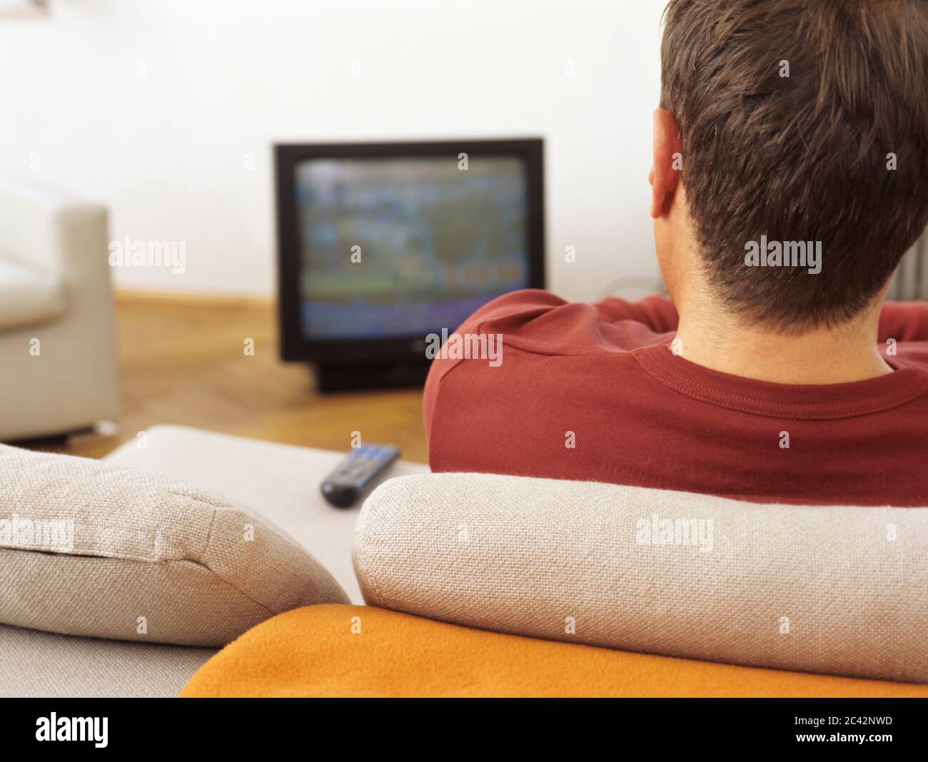 Man watching TV (rear view Stock Photo - Alamy