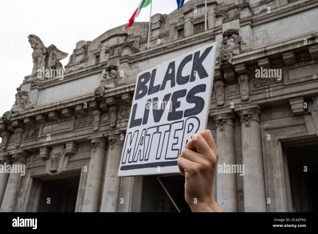 Hand of a young protester holding a sign with the words:"Black Lives ...