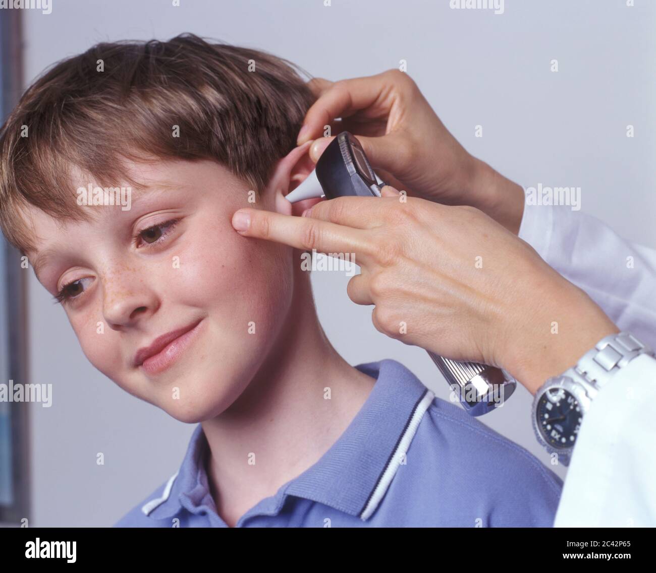 Female doctor examines the ear of a little boy - doctor's visit ...