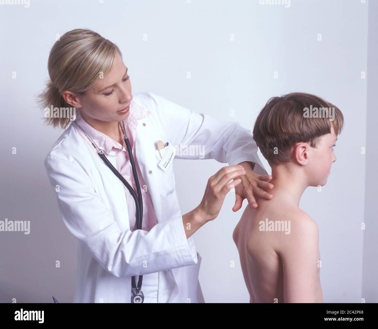 Young blonde doctor examines the spine of a little boy - doctor's visit ...