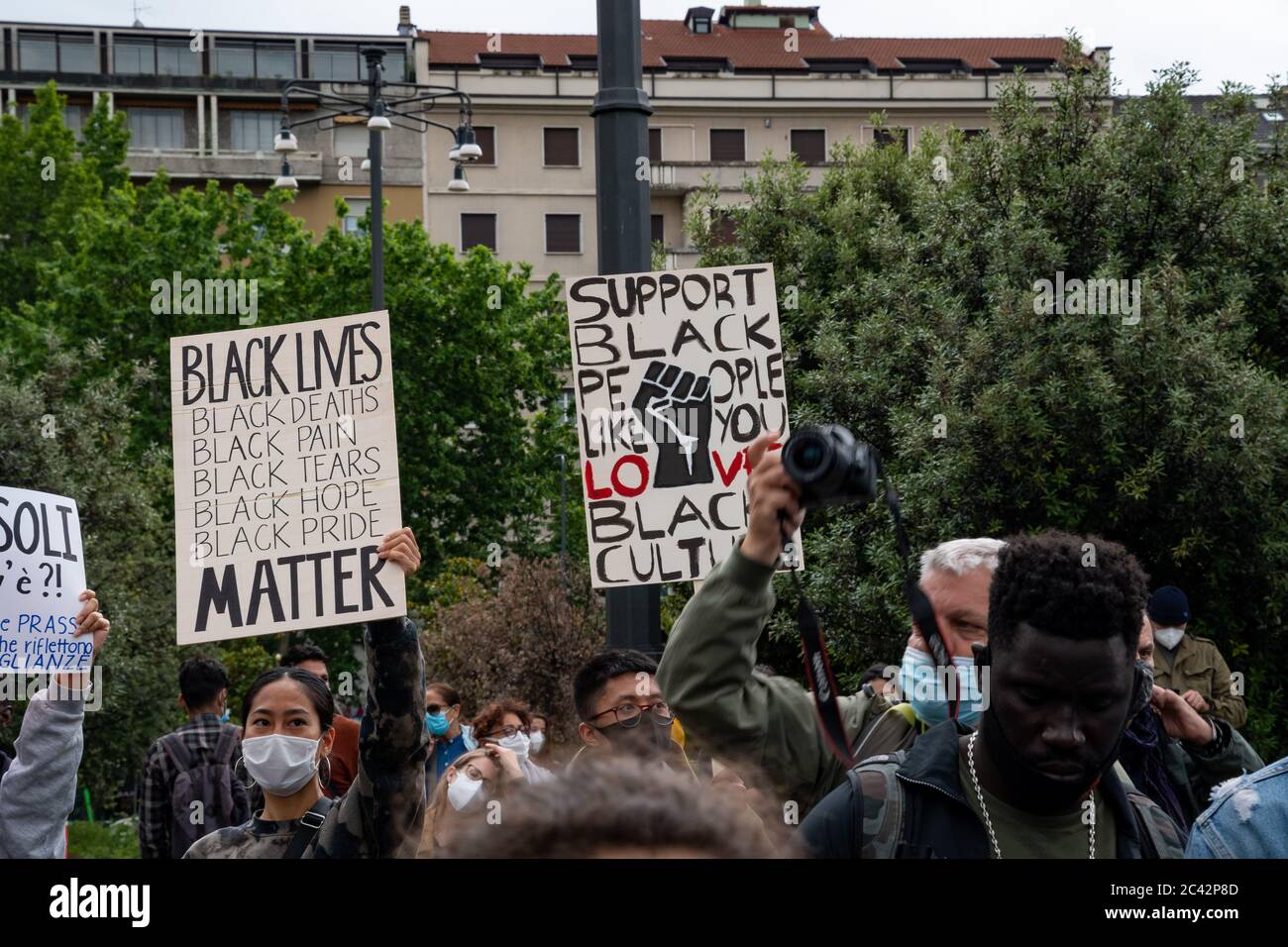 Protesters holding placards "Support Black People", "Black Lives ...
