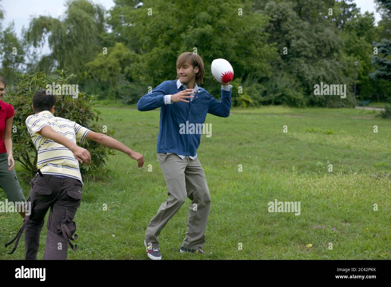 Group of young people playing ball Stock Photo - Alamy