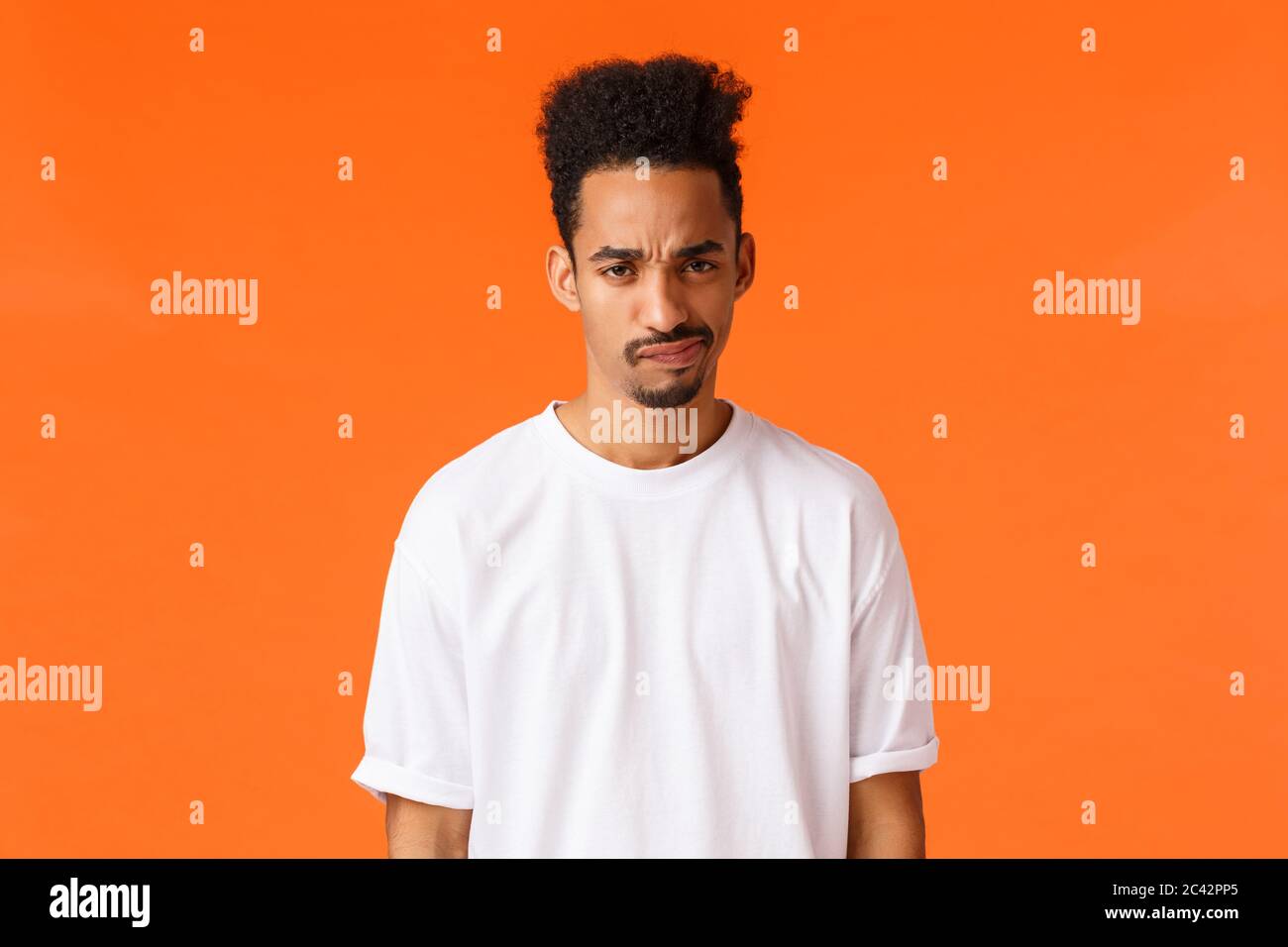 Displeased young african-american skeptical man, frowning and smirk ...