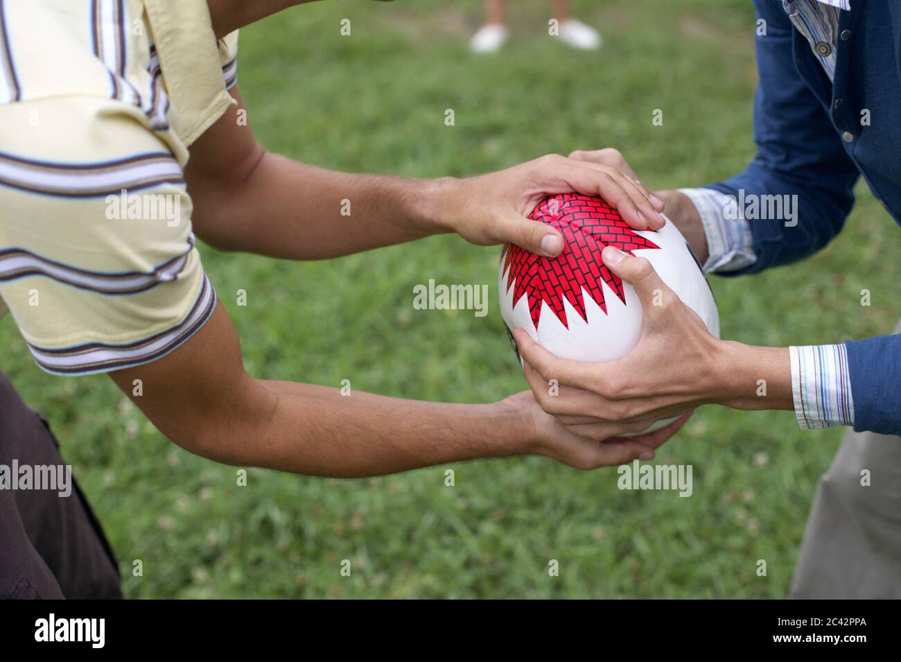 Two people fight for a ball Stock Photo - Alamy