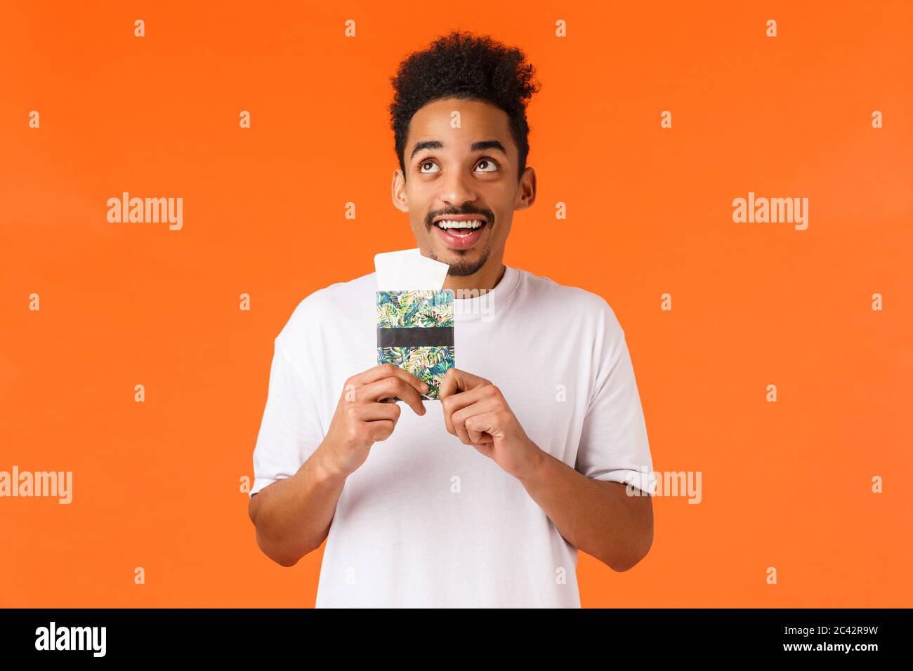 Dreamy cheerful, smiling african-american guy with moustache, afro ...