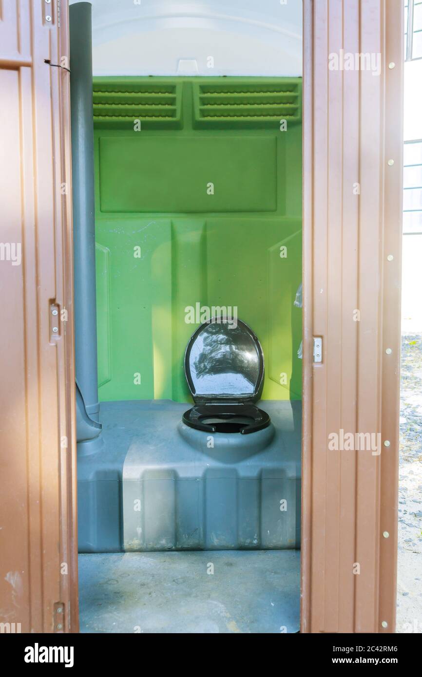 Open portable toilet at construction site for worker in a building ...