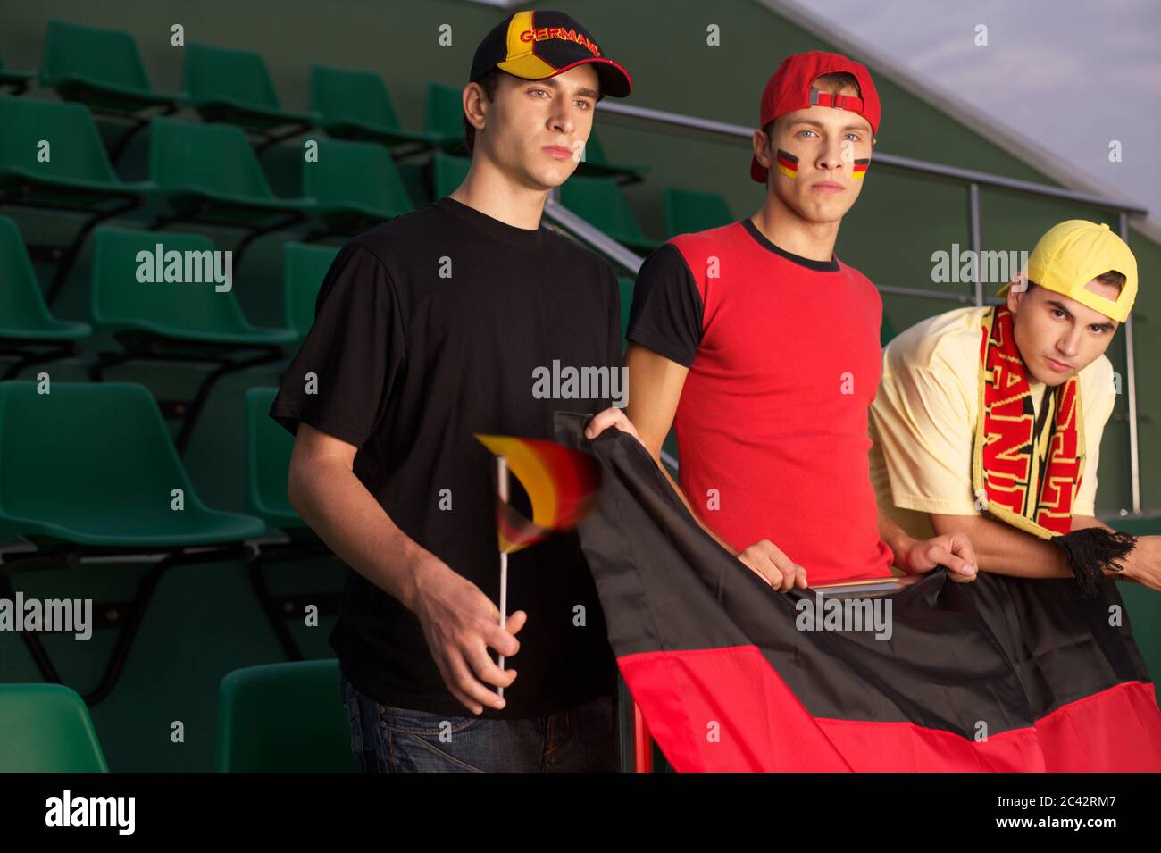 Three young German fans sit in the stadium Stock Photo - Alamy