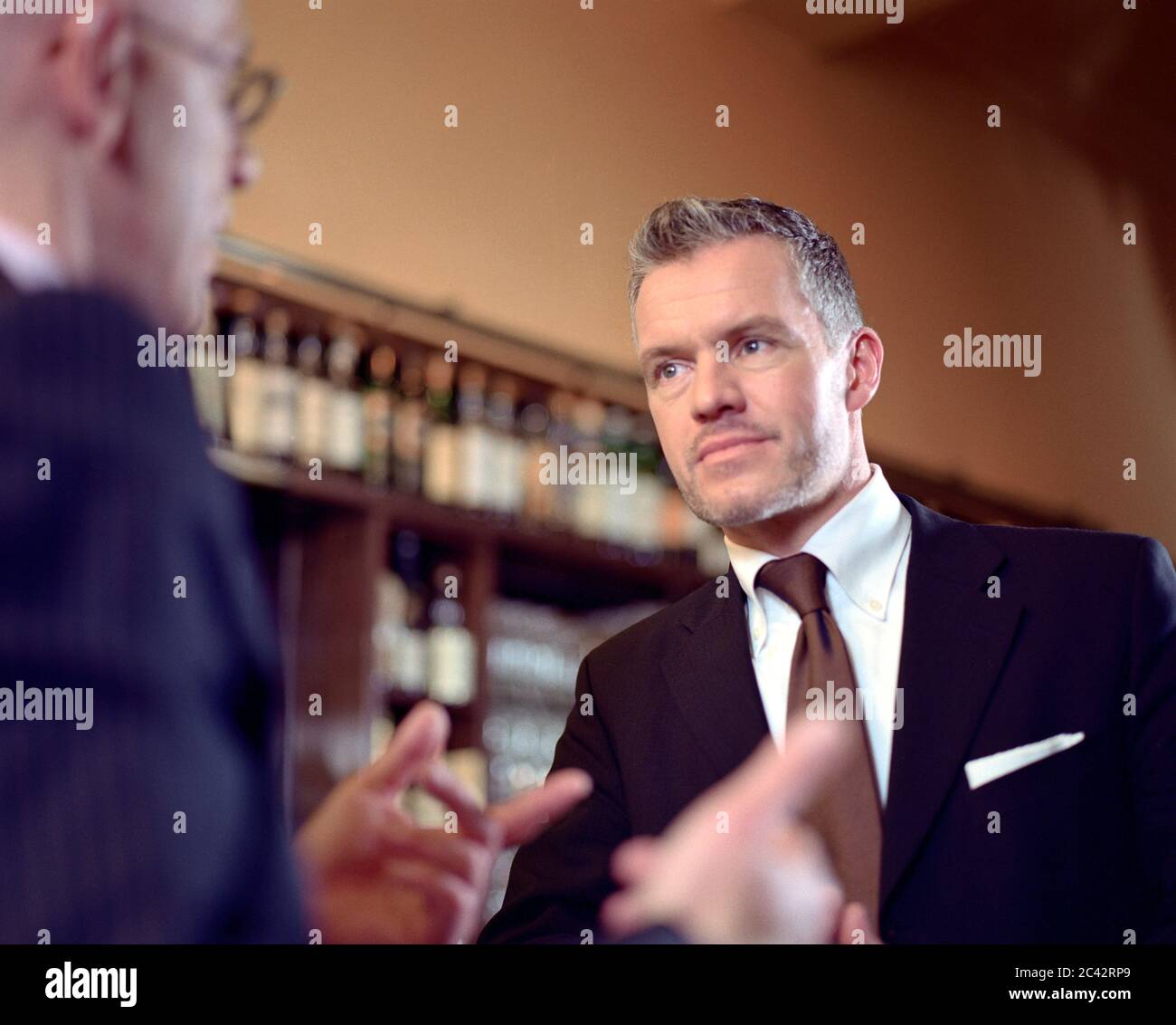 Two businessmen are talking - bar Stock Photo - Alamy