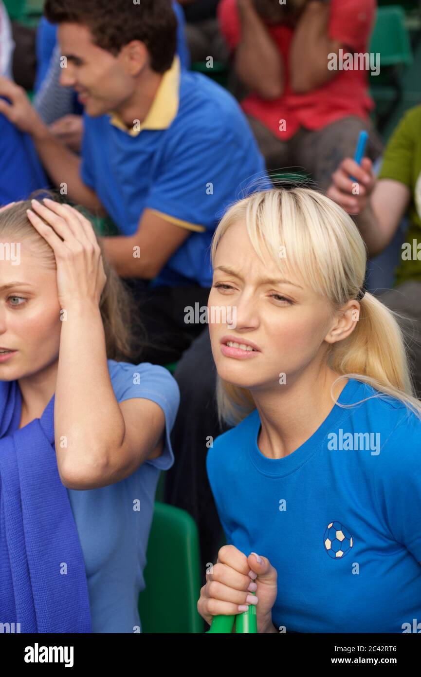 Two disappointed female fans in the stadium Stock Photo - Alamy