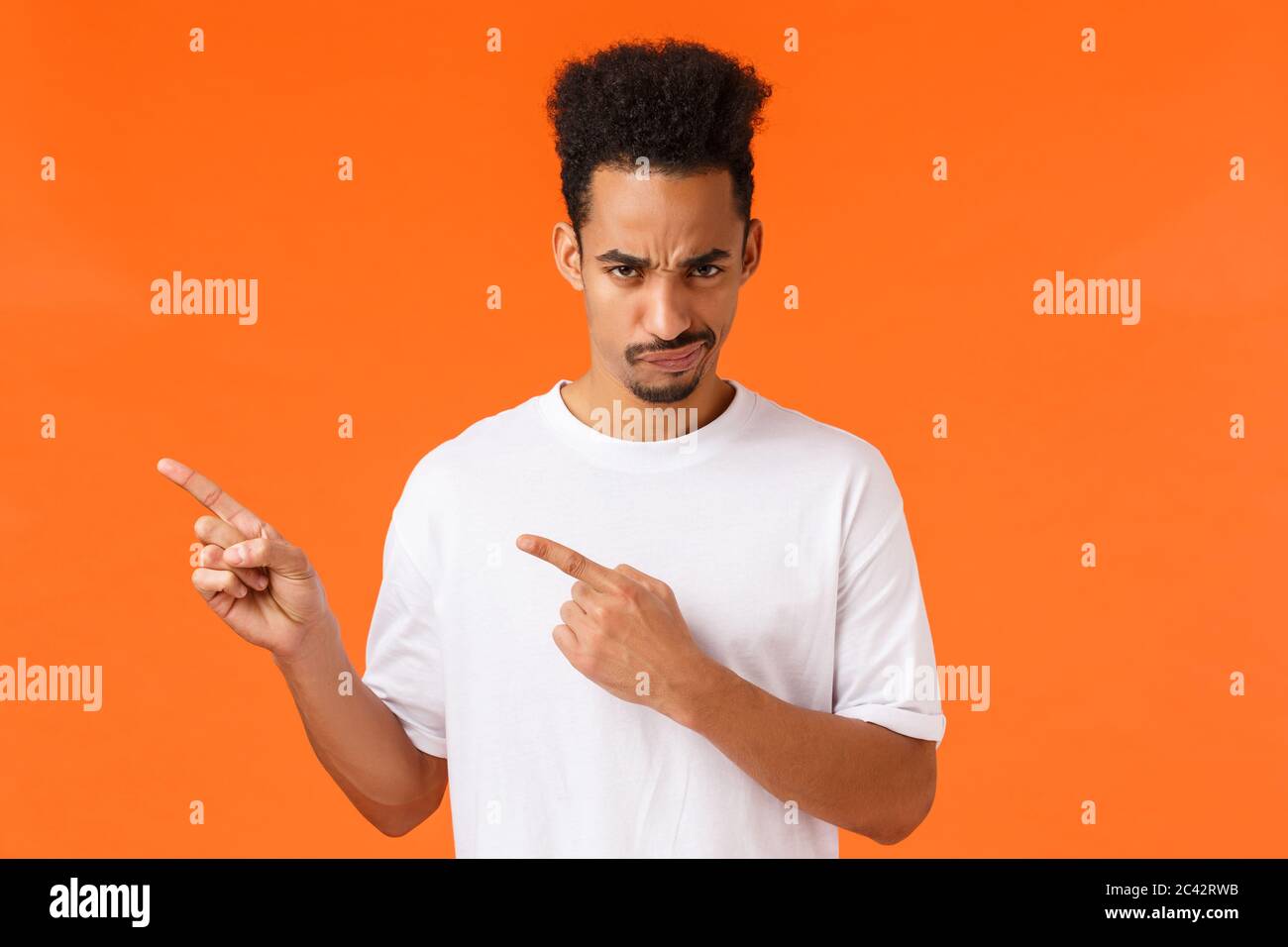 Skeptical, displeased young african-american man with moustache ...