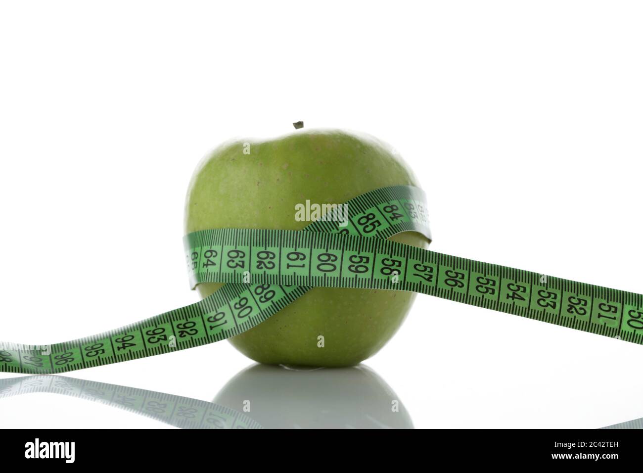Green tape measure wrapped around an apple - metaphor - fruit - diet ...