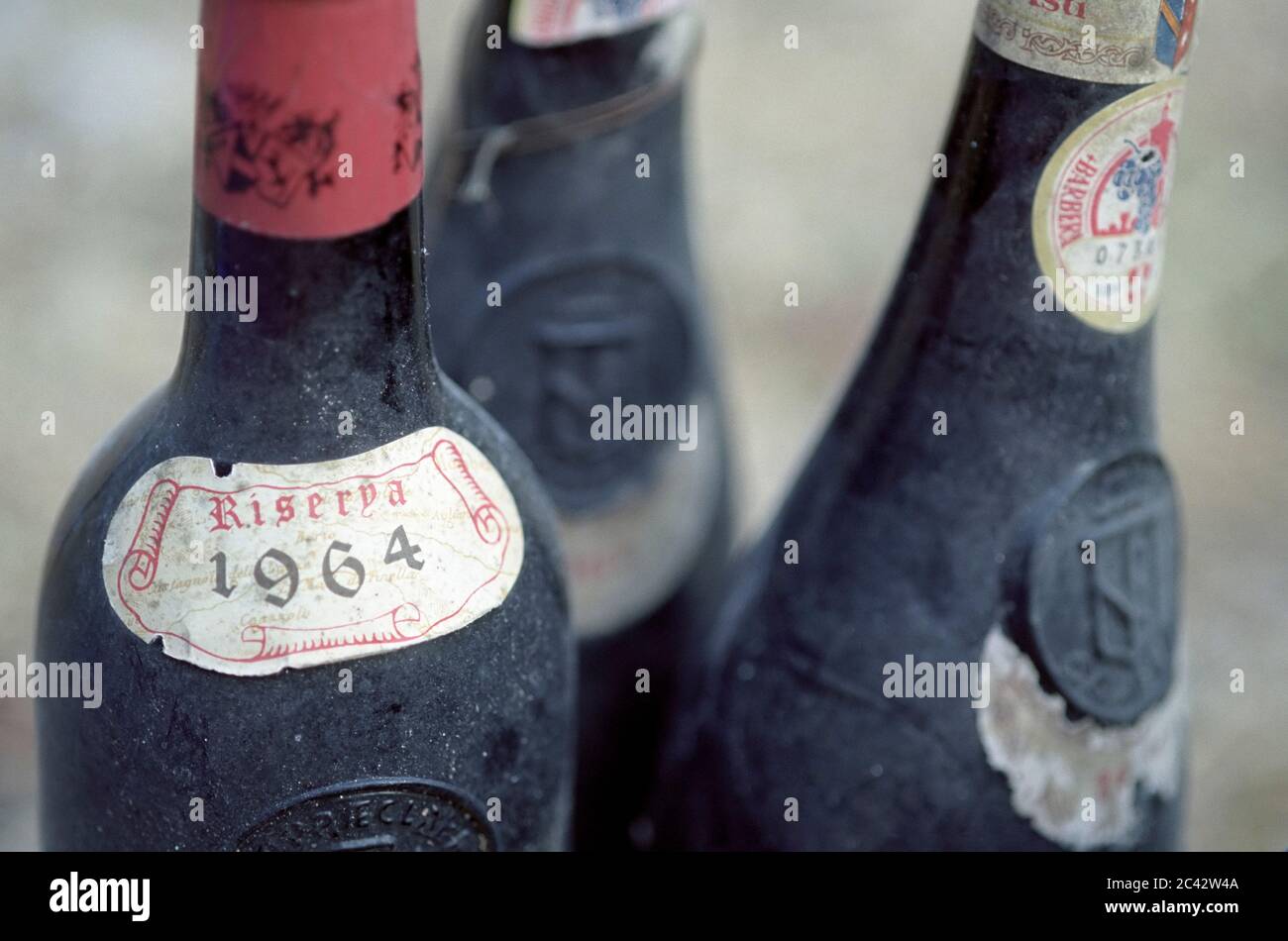 Three old dusty wine bottles - consumption - enjoyment Stock Photo - Alamy