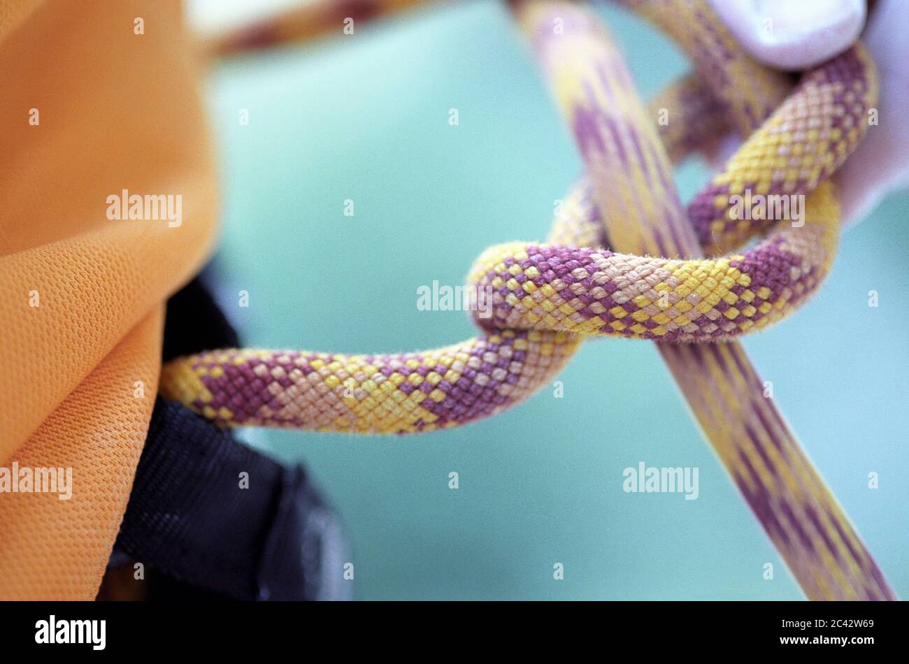 Person fastens a climbing rope to the waist - equipment - close-up ...