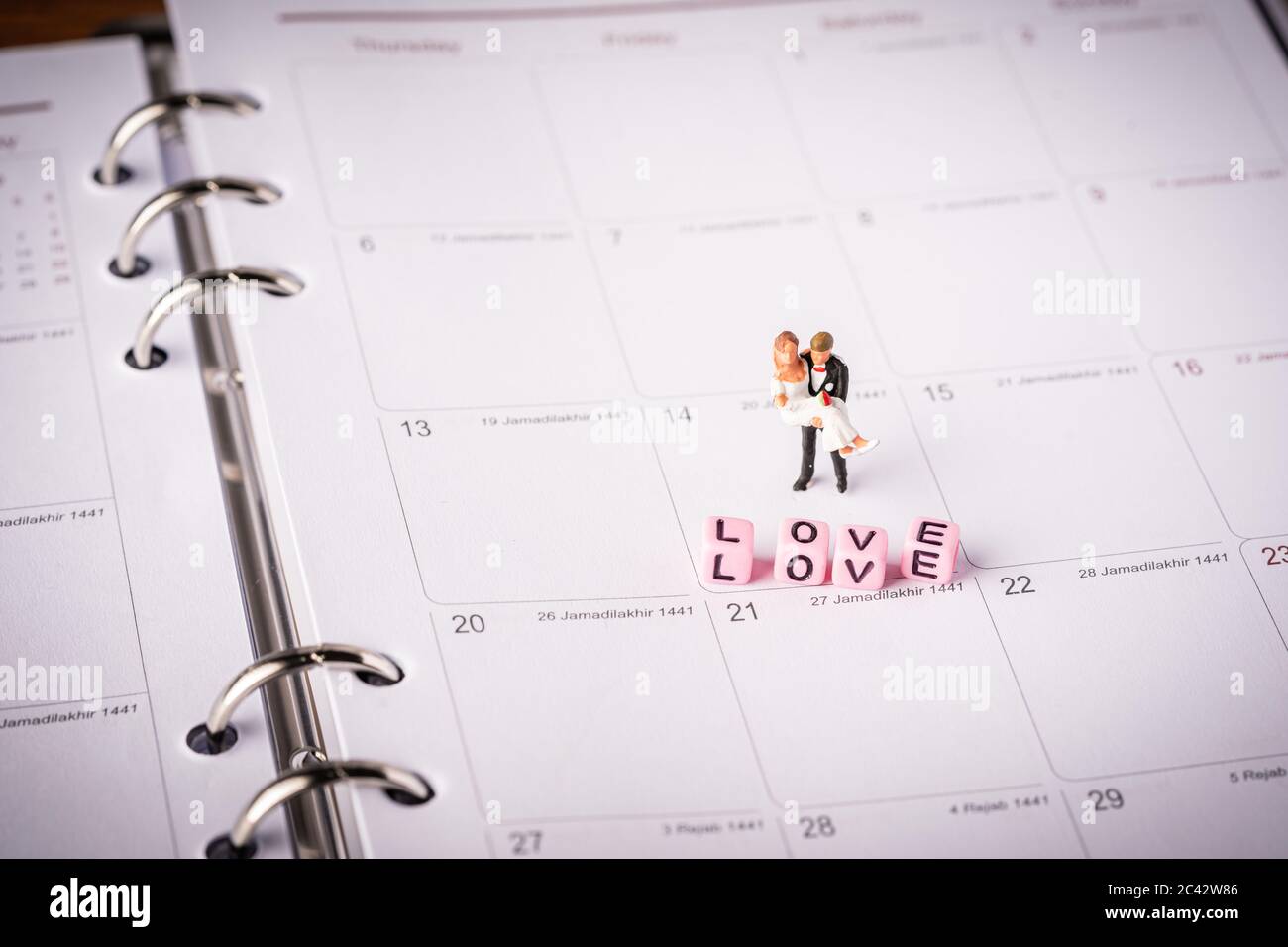 Love concept. Miniature couple against pink background Stock Photo - Alamy